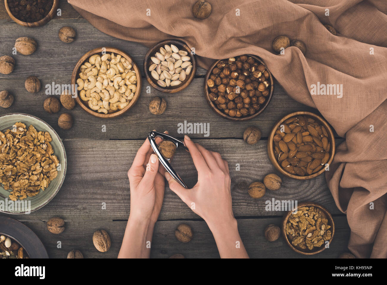 person cracking walnut Stock Photo - Alamy