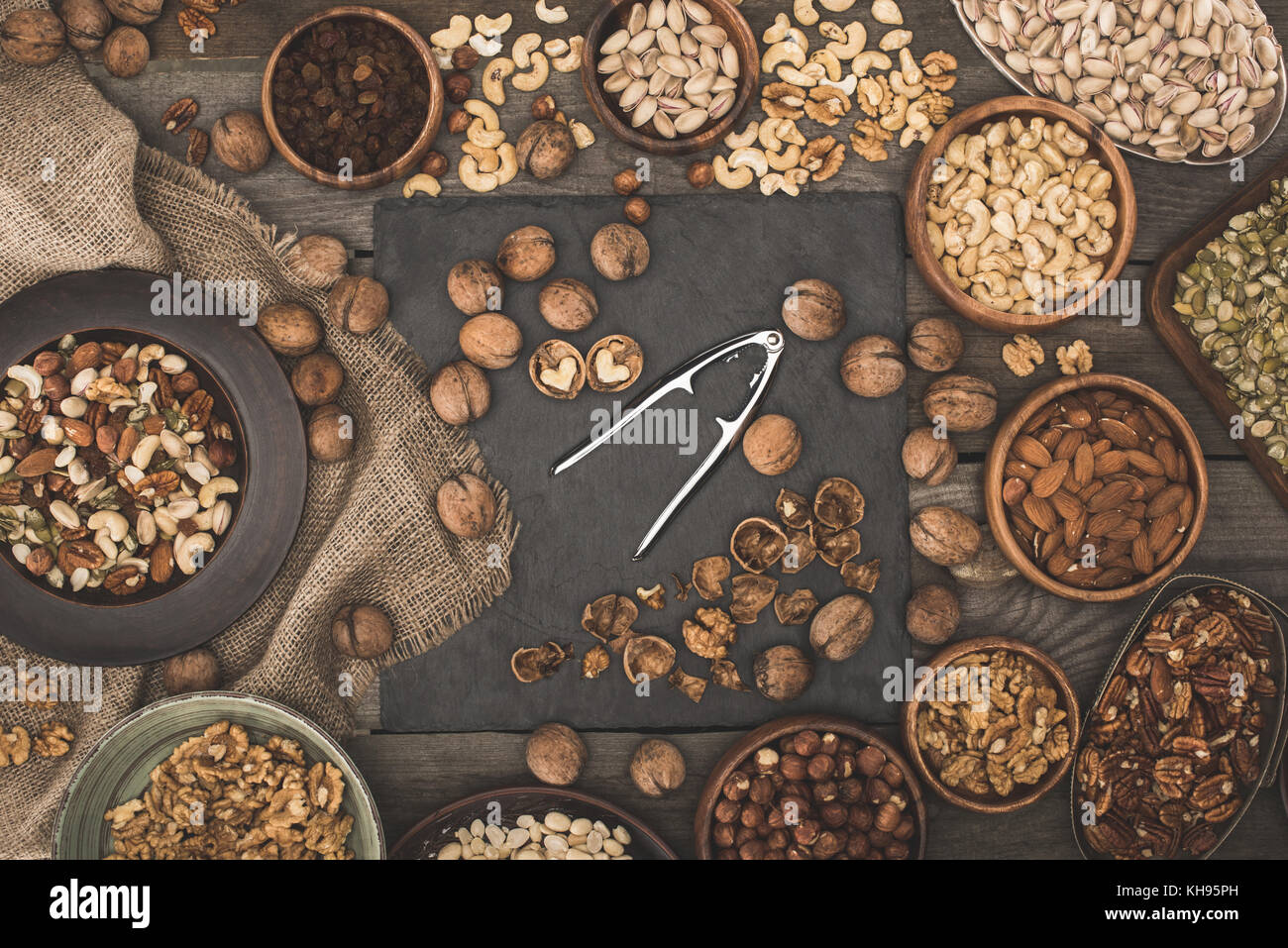 various nuts on wooden table top Stock Photo - Alamy