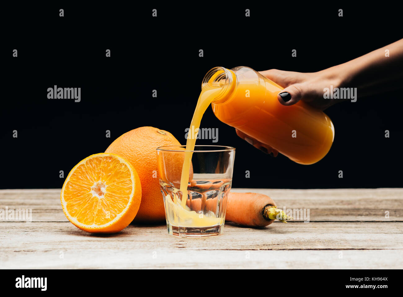 woman pouring fresh juice into glass Stock Photo - Alamy