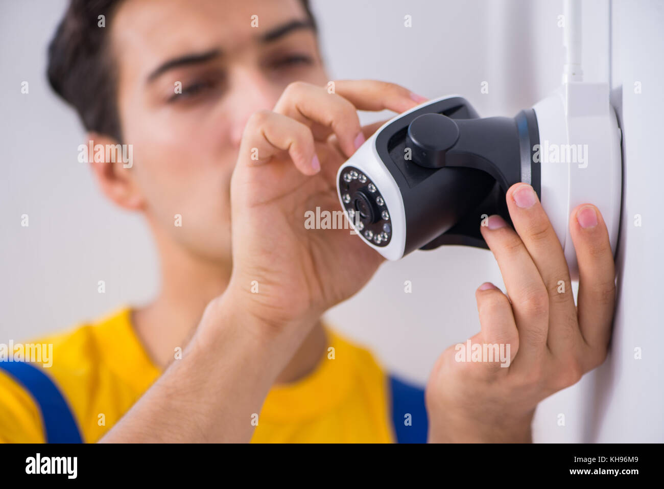 Contractor installing surveillance CCTV cameras in office Stock Photo ...