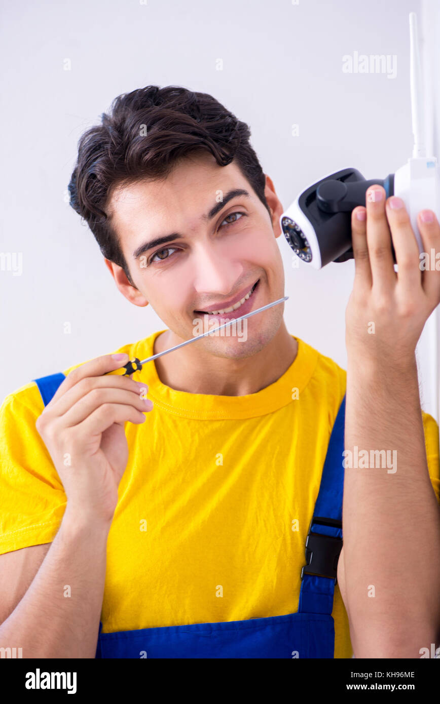 Contractor installing surveillance CCTV cameras in office Stock Photo ...