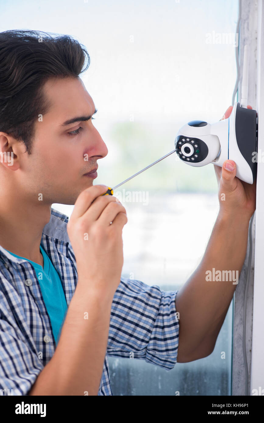 Man installing surveillance CCTV cameras at home Stock Photo - Alamy