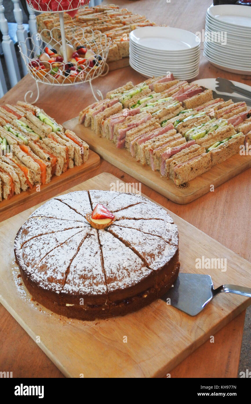 Selection of party food including chocolate cake and sandwiches - John ...