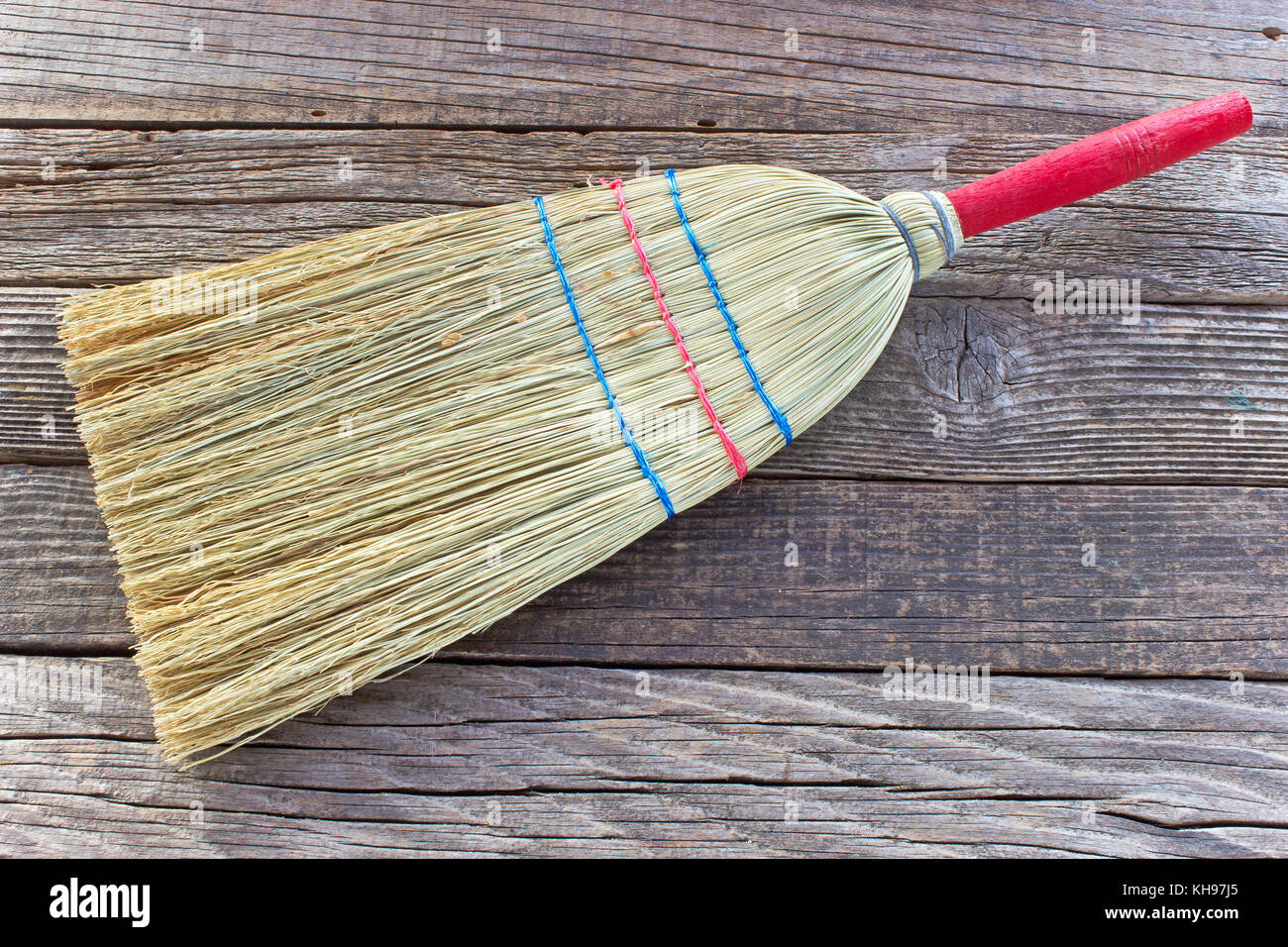 Small broom on wooden background Stock Photo - Alamy