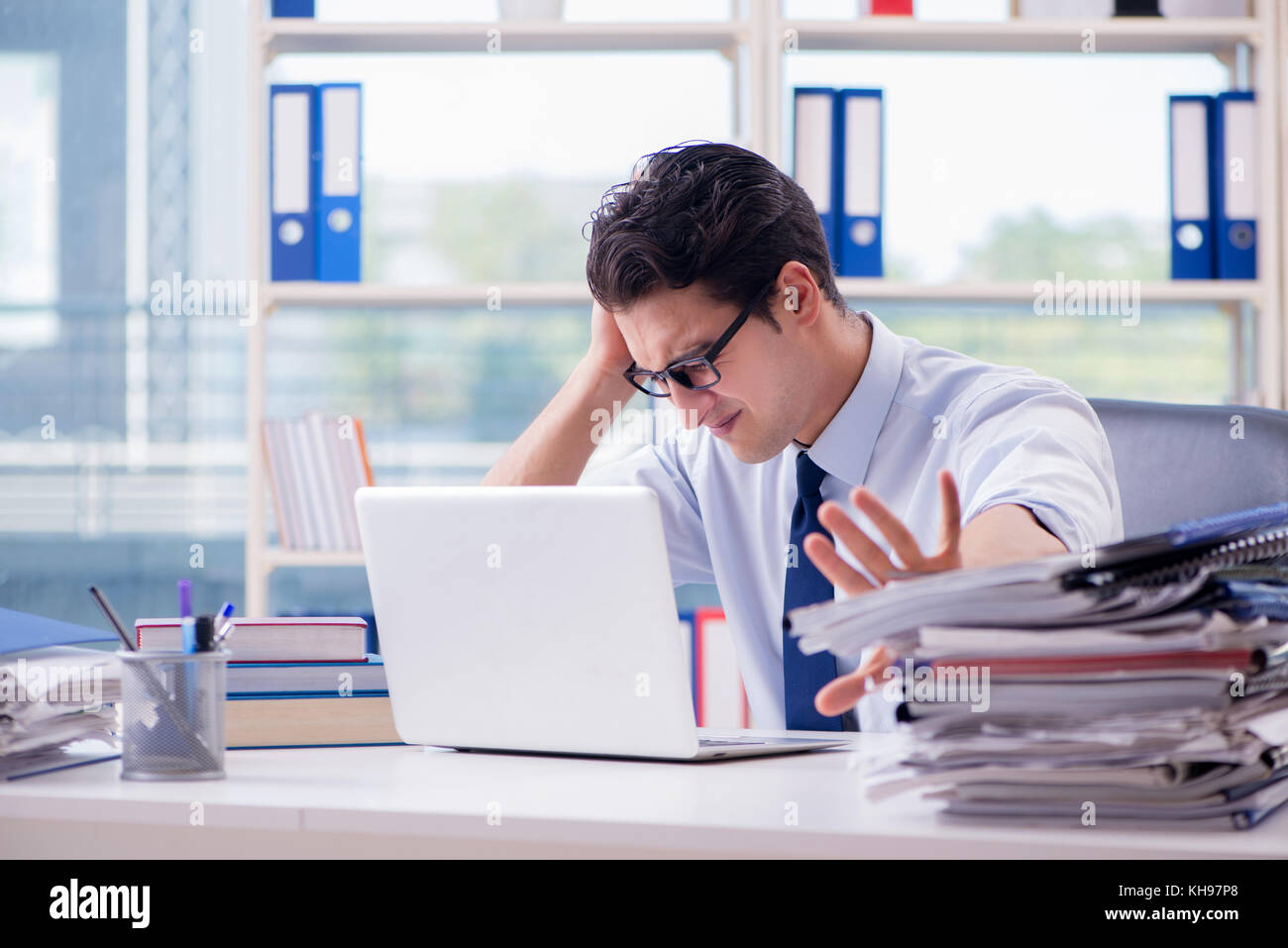 Businessman with excessive work paperwork working in office Stock Photo ...