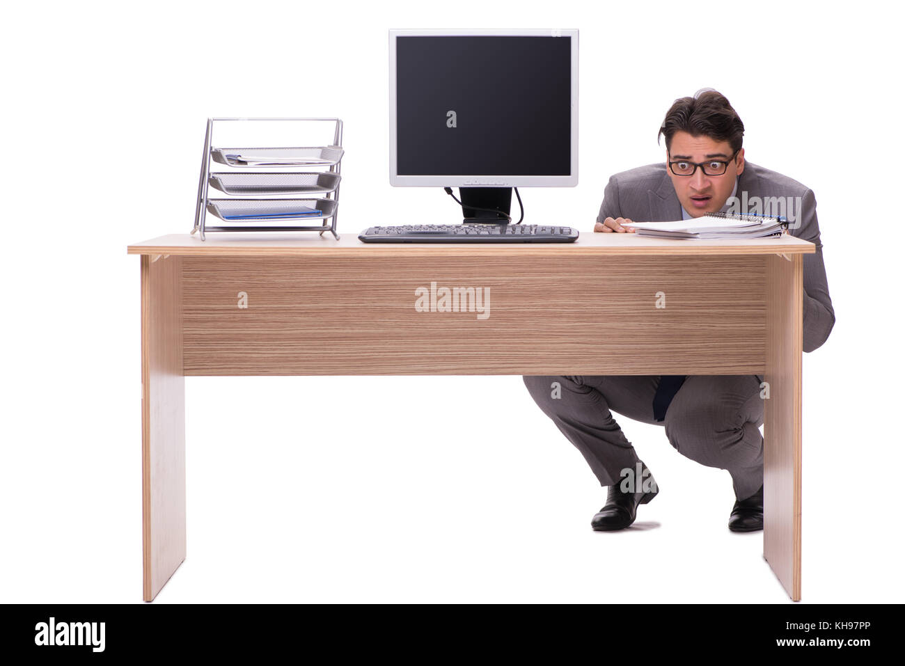 Businessman hiding in the office isolated on white Stock Photo - Alamy