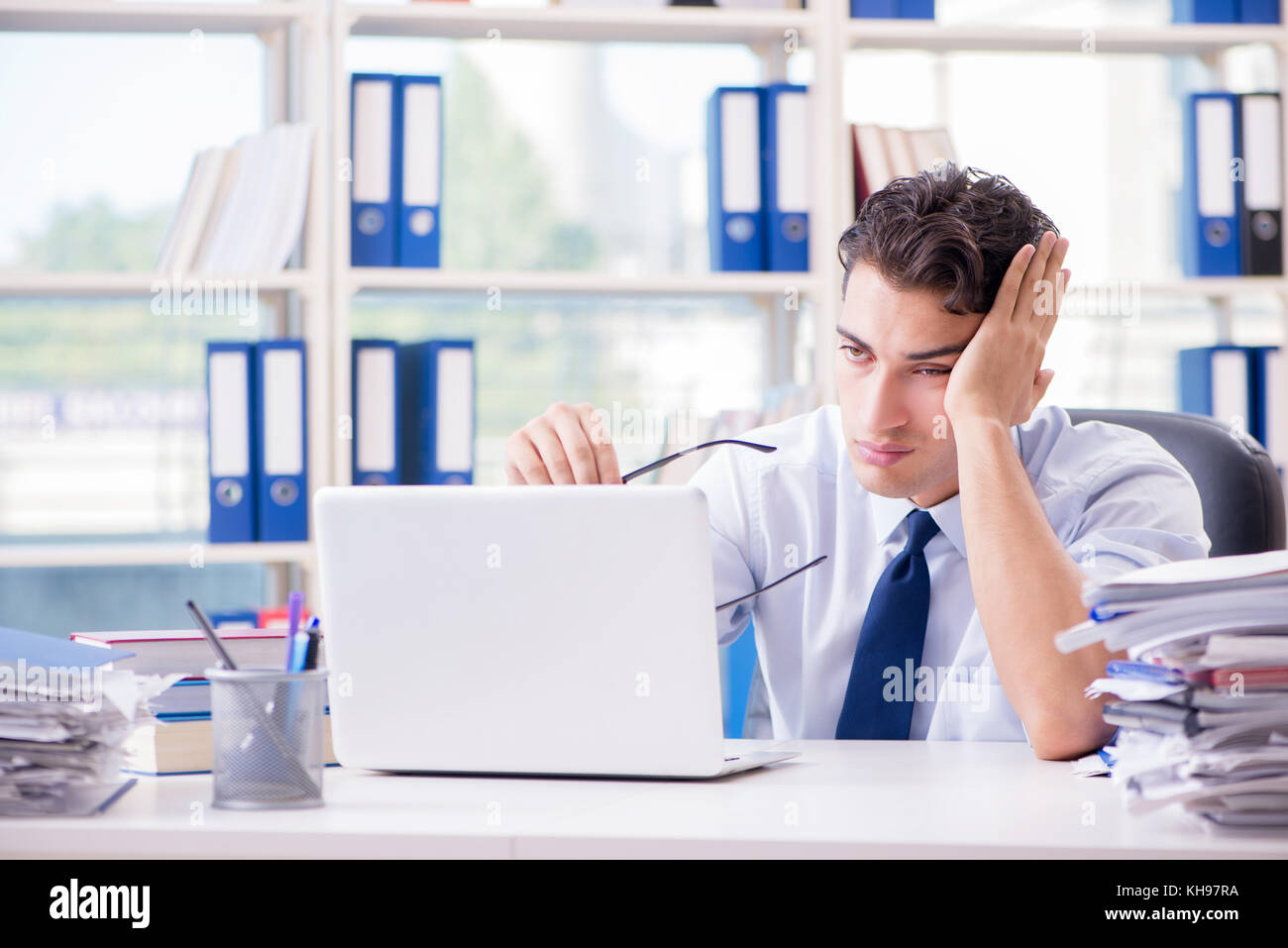 Tired exhausted businessman sitting in the office Stock Photo - Alamy