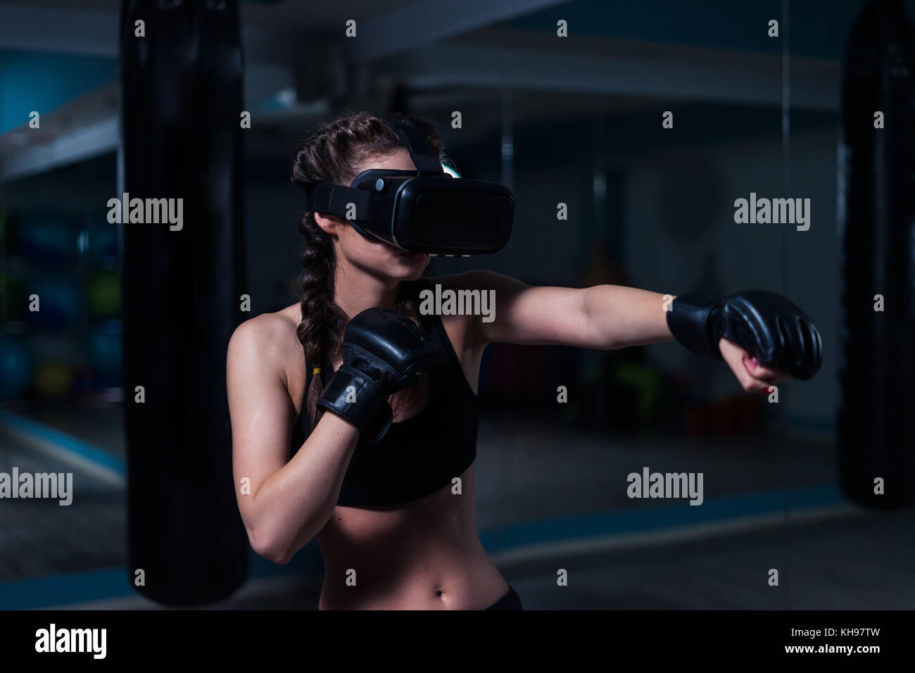 Young fighter boxer fit girl in VR glasses wearing boxing gloves Stock ...