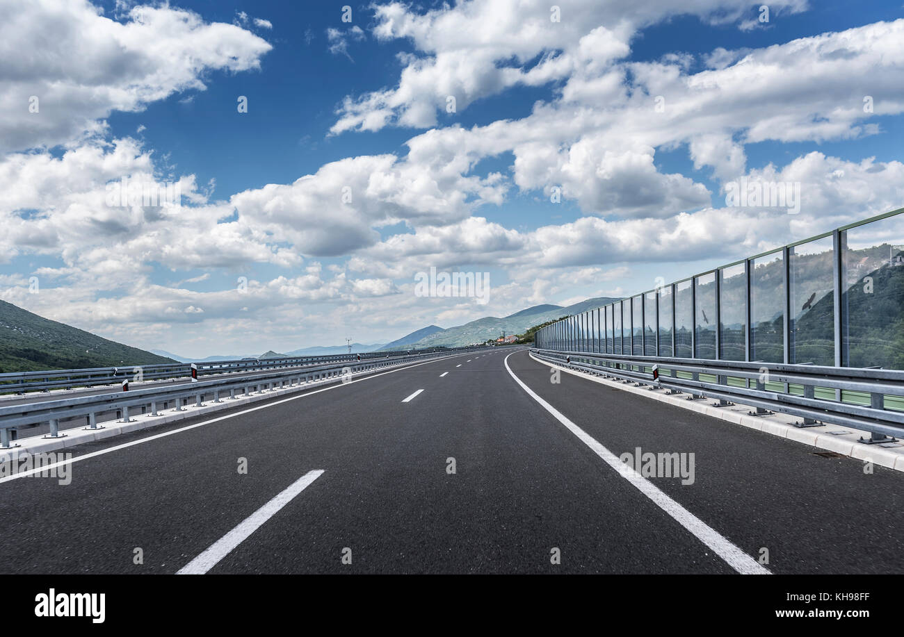 High-speed country road among the mountains Stock Photo - Alamy