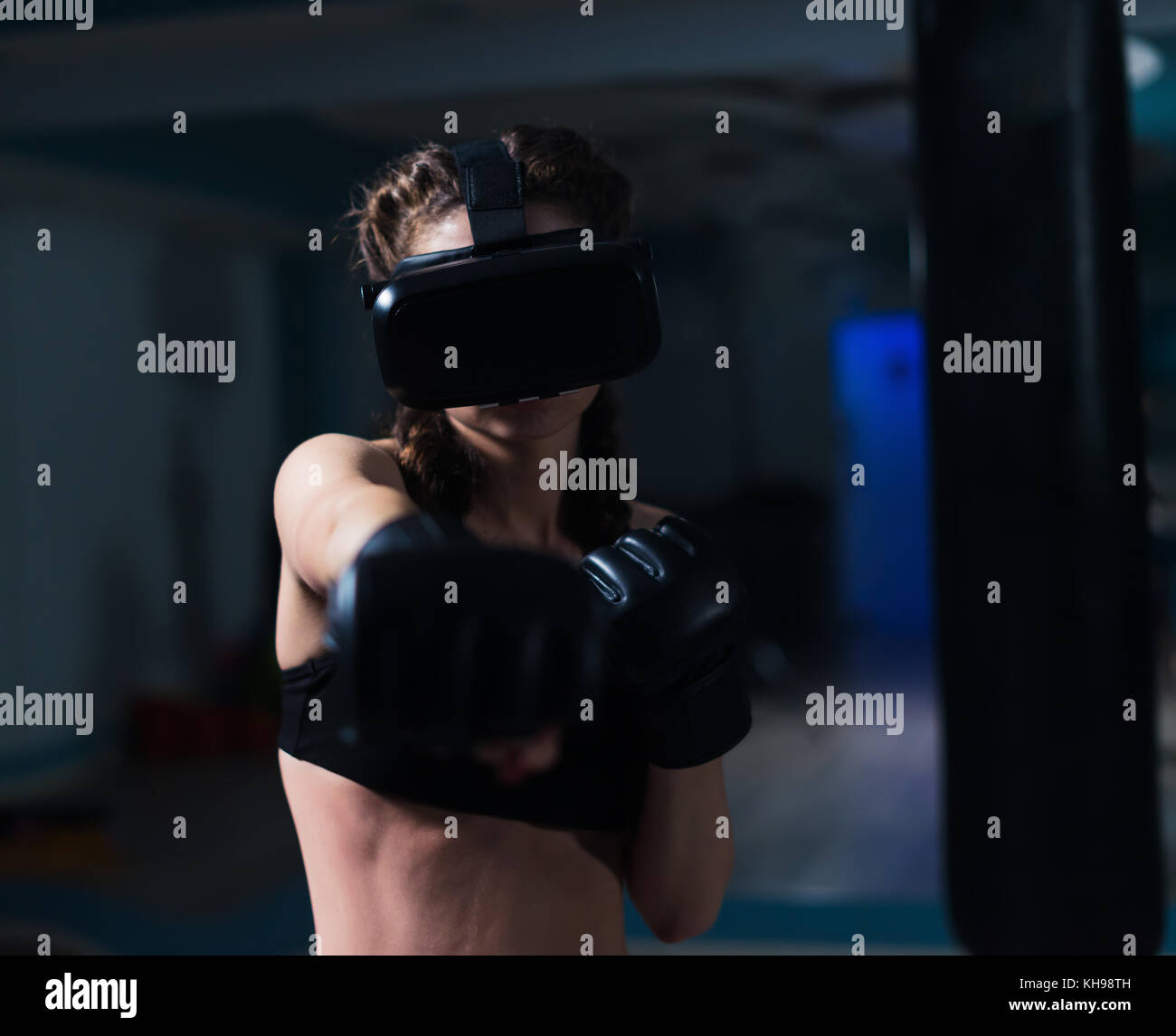 Young fighter boxer fit girl in VR glasses wearing boxing gloves Stock ...