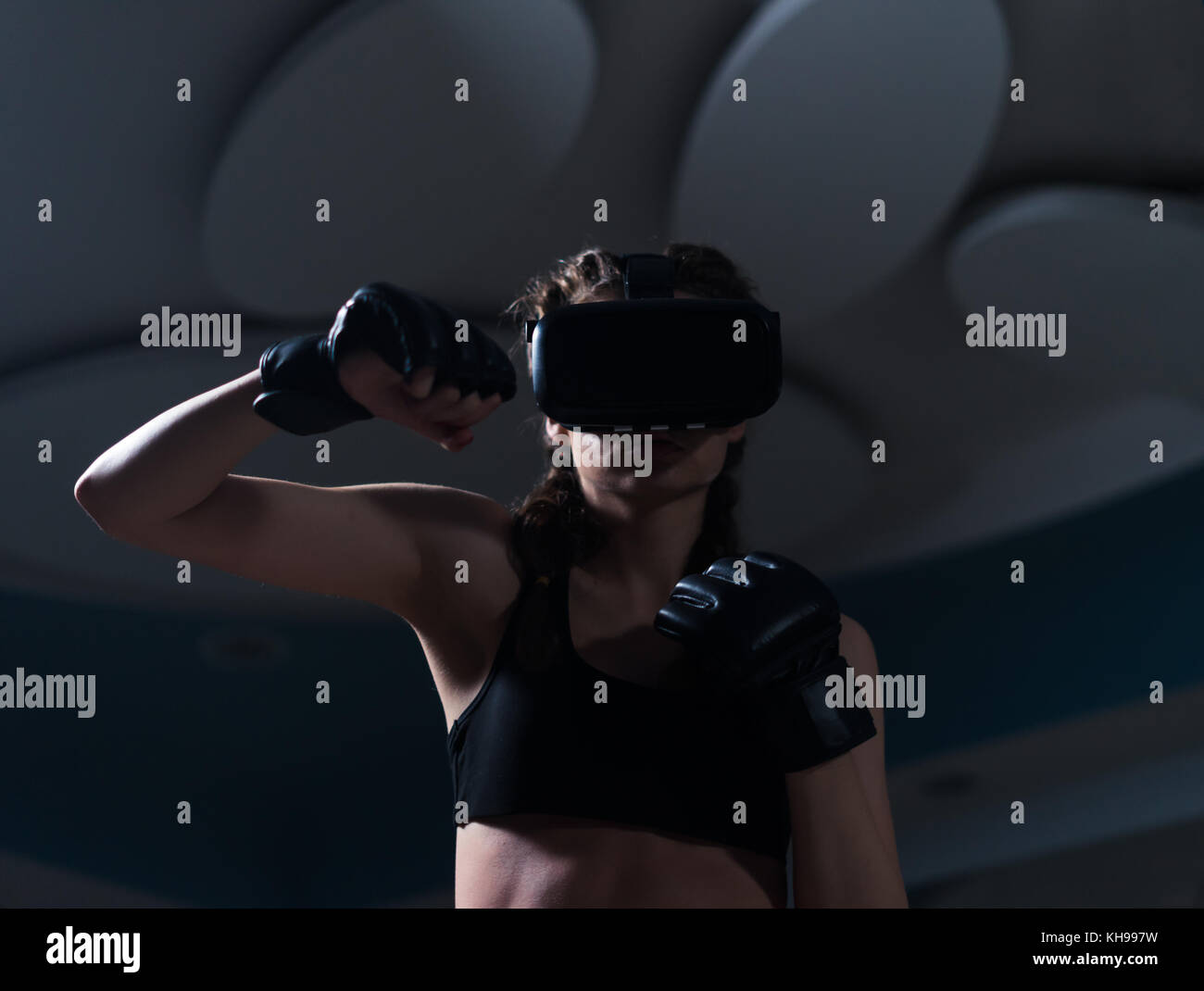 Young fighter boxer fit girl in VR glasses wearing boxing gloves Stock ...