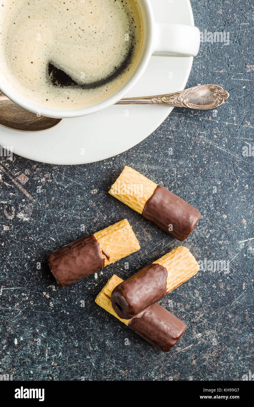 Sweet dessert. Biscuits rolls with chocolate icing and coffee cup Stock ...