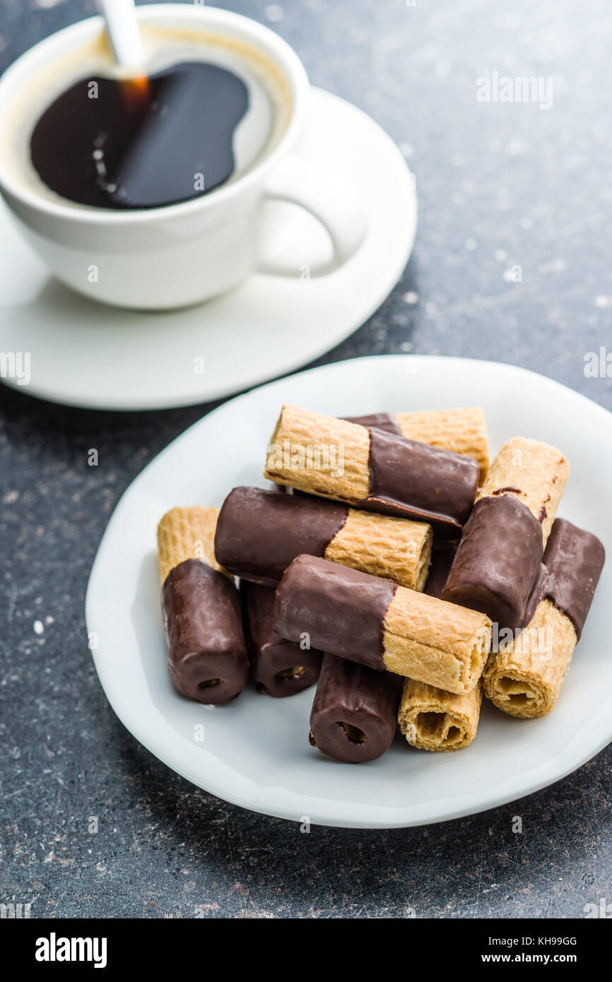 Sweet dessert. Biscuits rolls with chocolate icing and coffee cup Stock ...