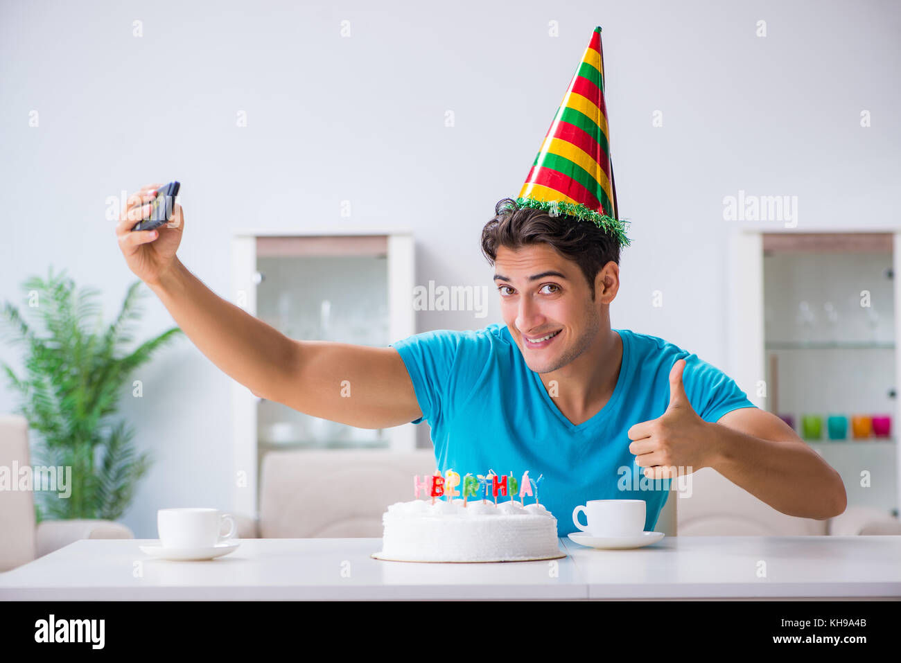 Young man celebrating birthday alone at home Stock Photo - Alamy