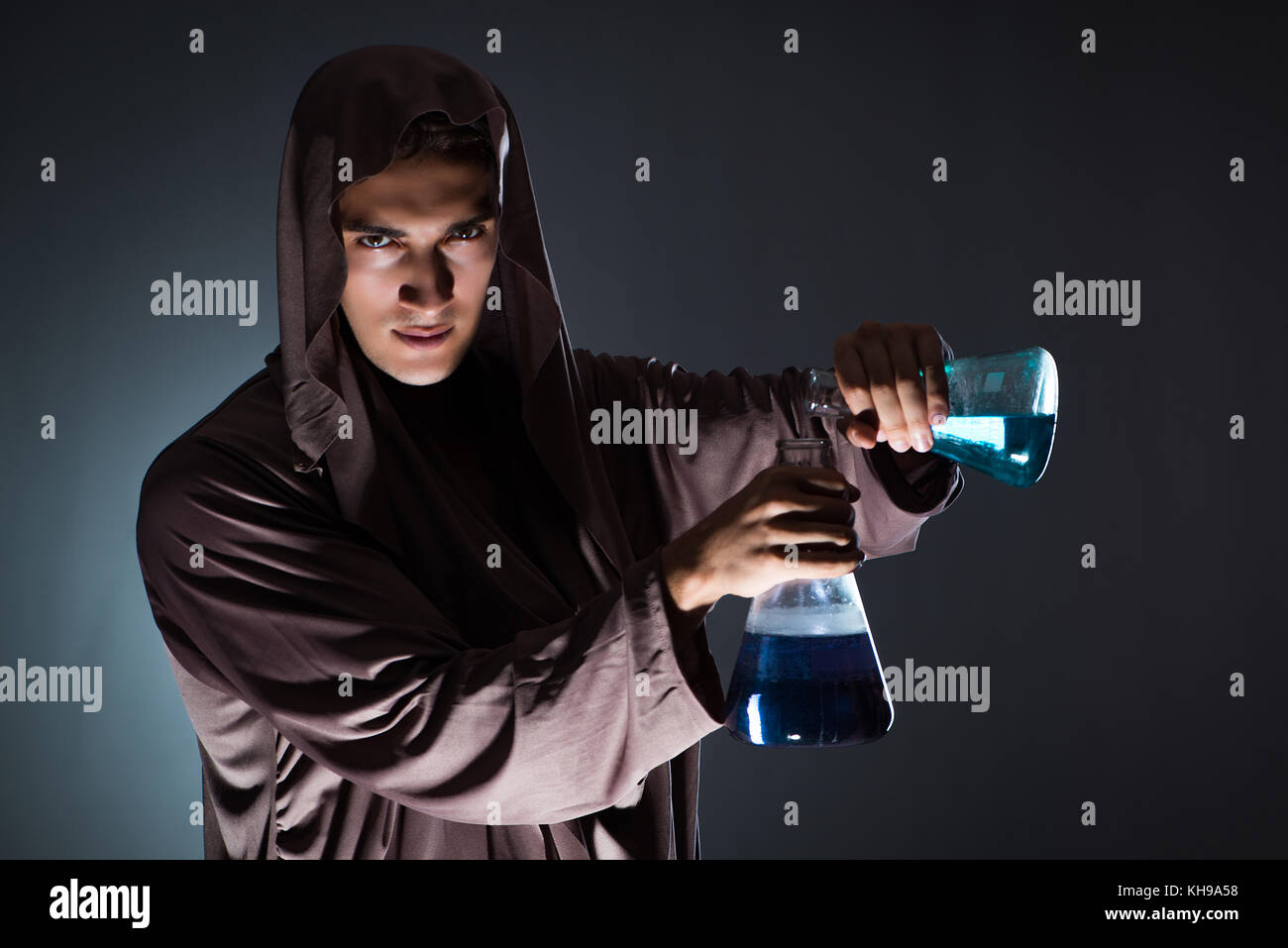 Alchemist doing experiments in alchemy concept Stock Photo - Alamy