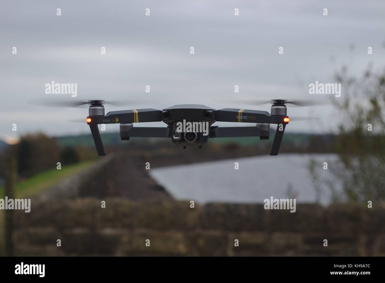 DJI Mavic drone in mid flight with lights on and camera showing Stock ...