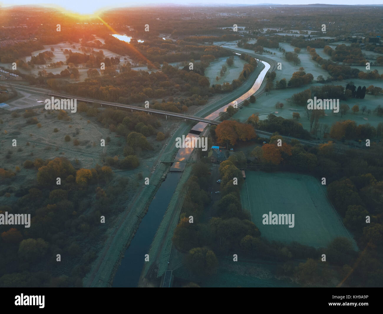 aerial drone view of trees, grass, houses, land, river sunrise Stock ...