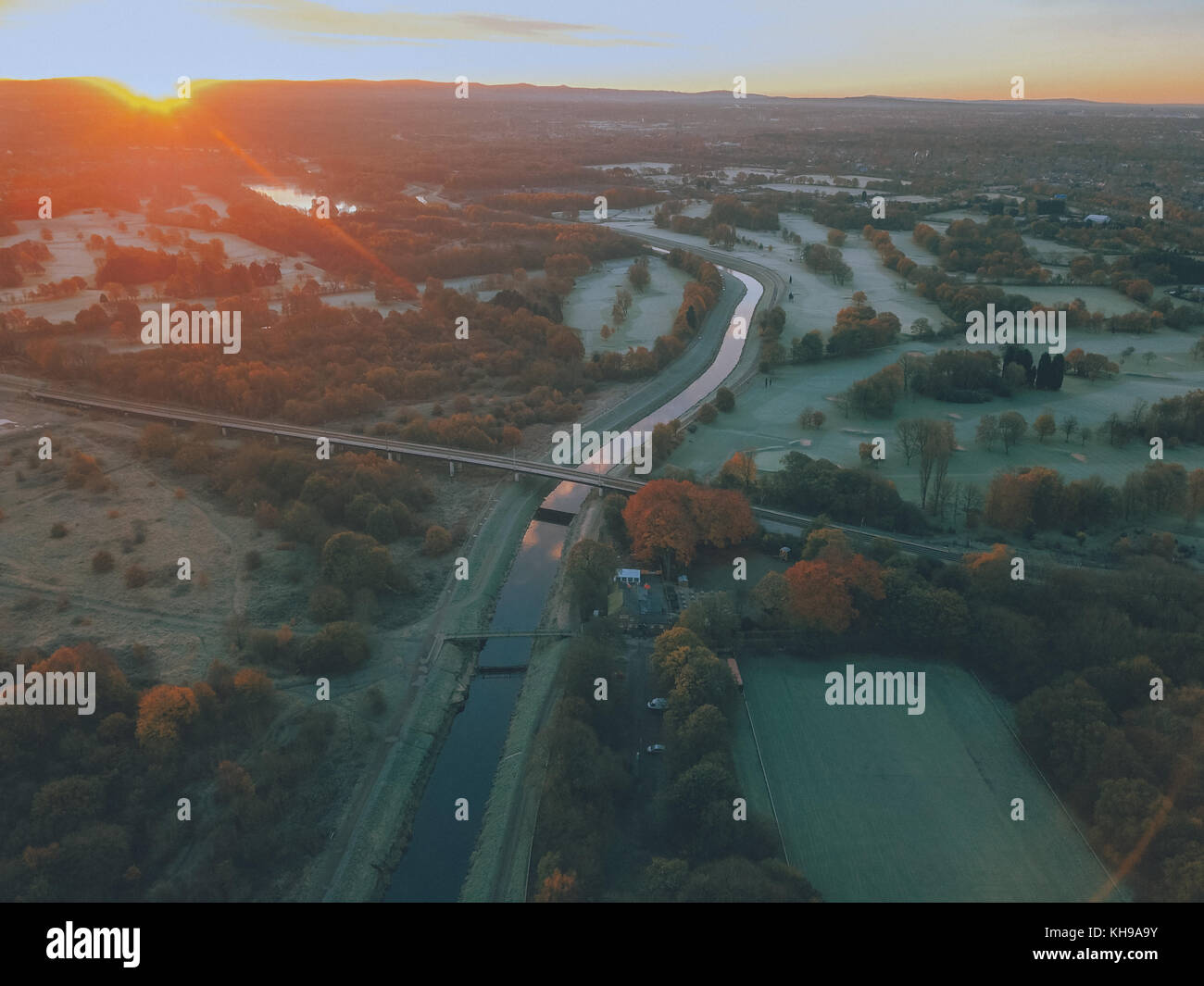 aerial drone view of trees, grass, houses, land, river sunrise Stock ...