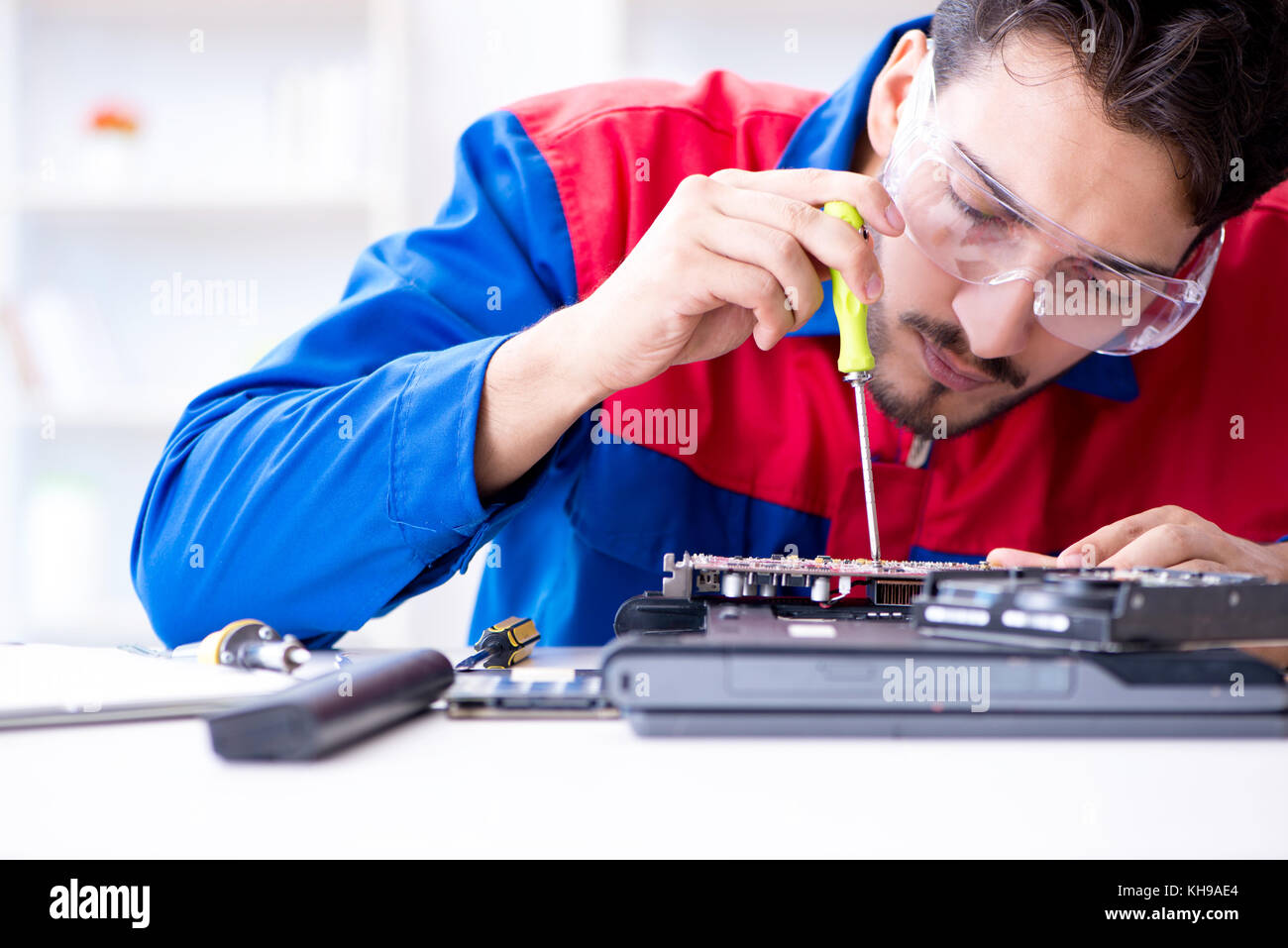 Repairman working in technical support fixing computer laptop ...