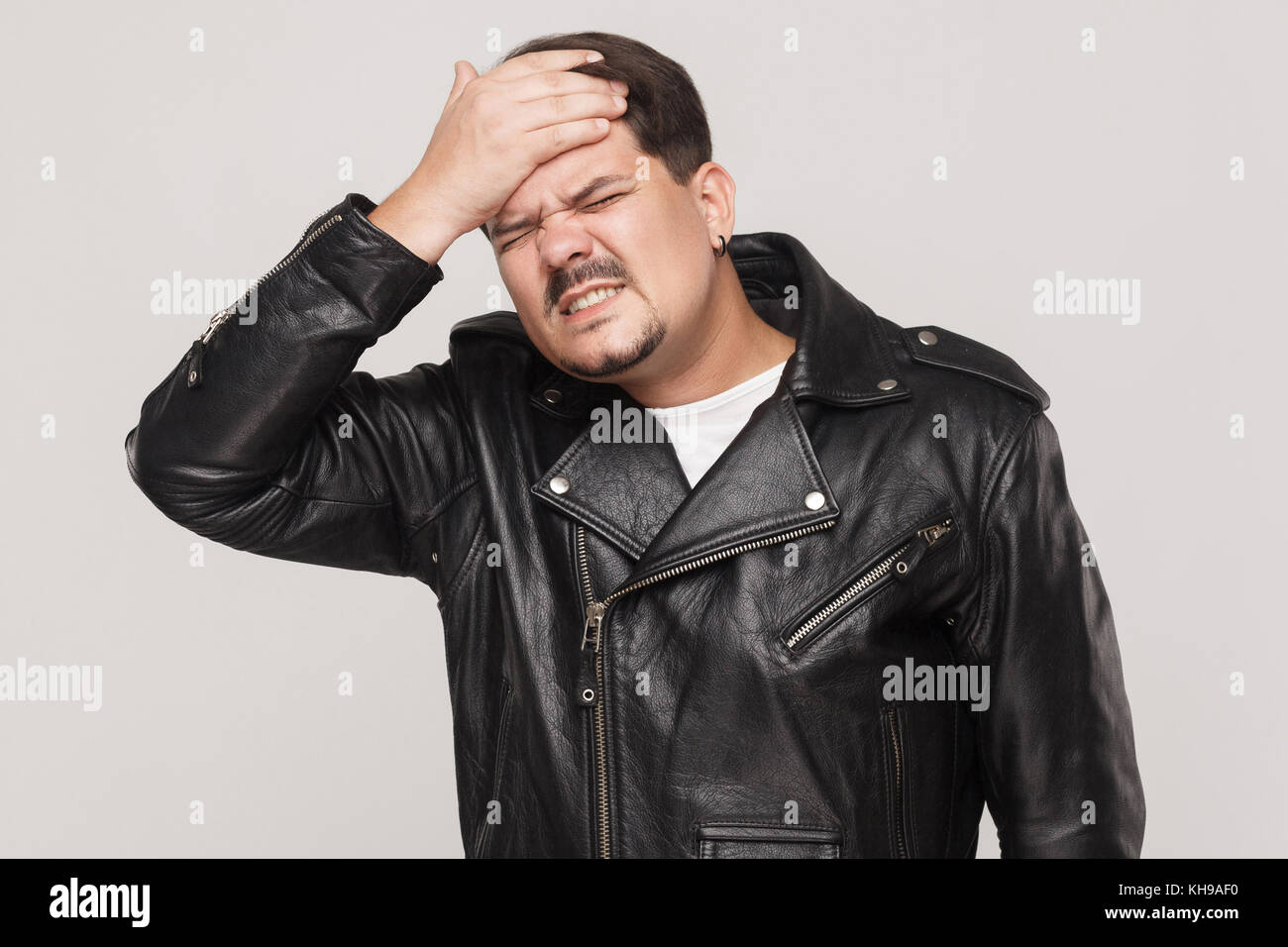 Distressed man have a problem. Touching head and have headache. Indoot ...