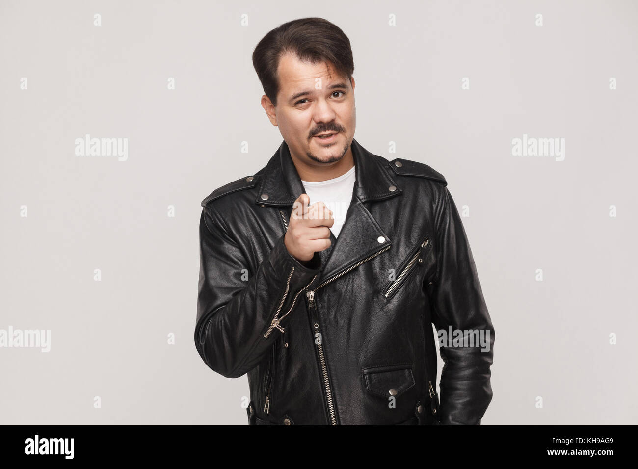 Warning sign. Biker pointing finger at camera. Studio shot Stock Photo ...