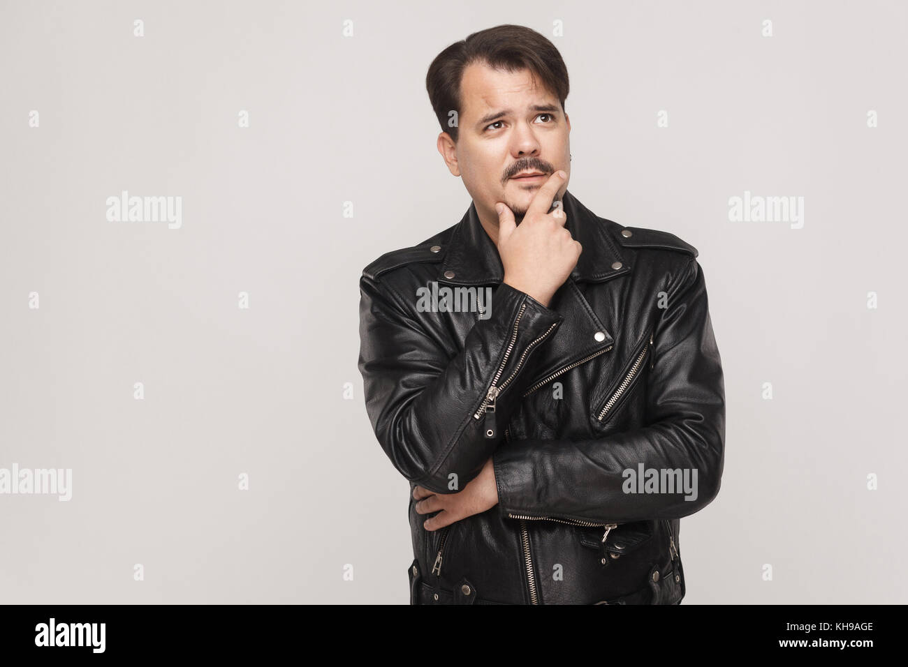 Hmm, lets my think. Pleased, confusion concept. Man in black jacket ...