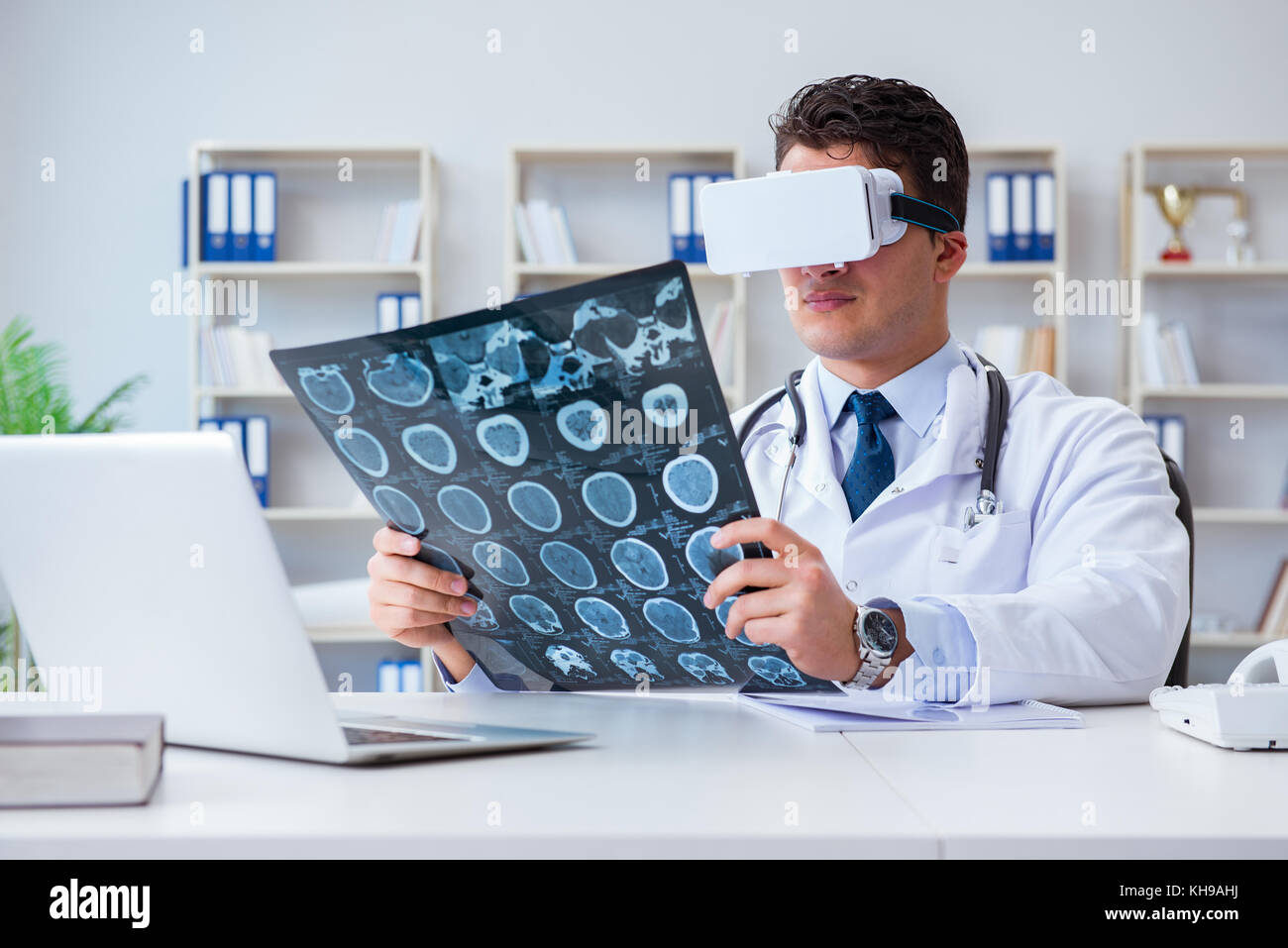 Young doctor looking at MRI scan through VR glasses Stock Photo - Alamy