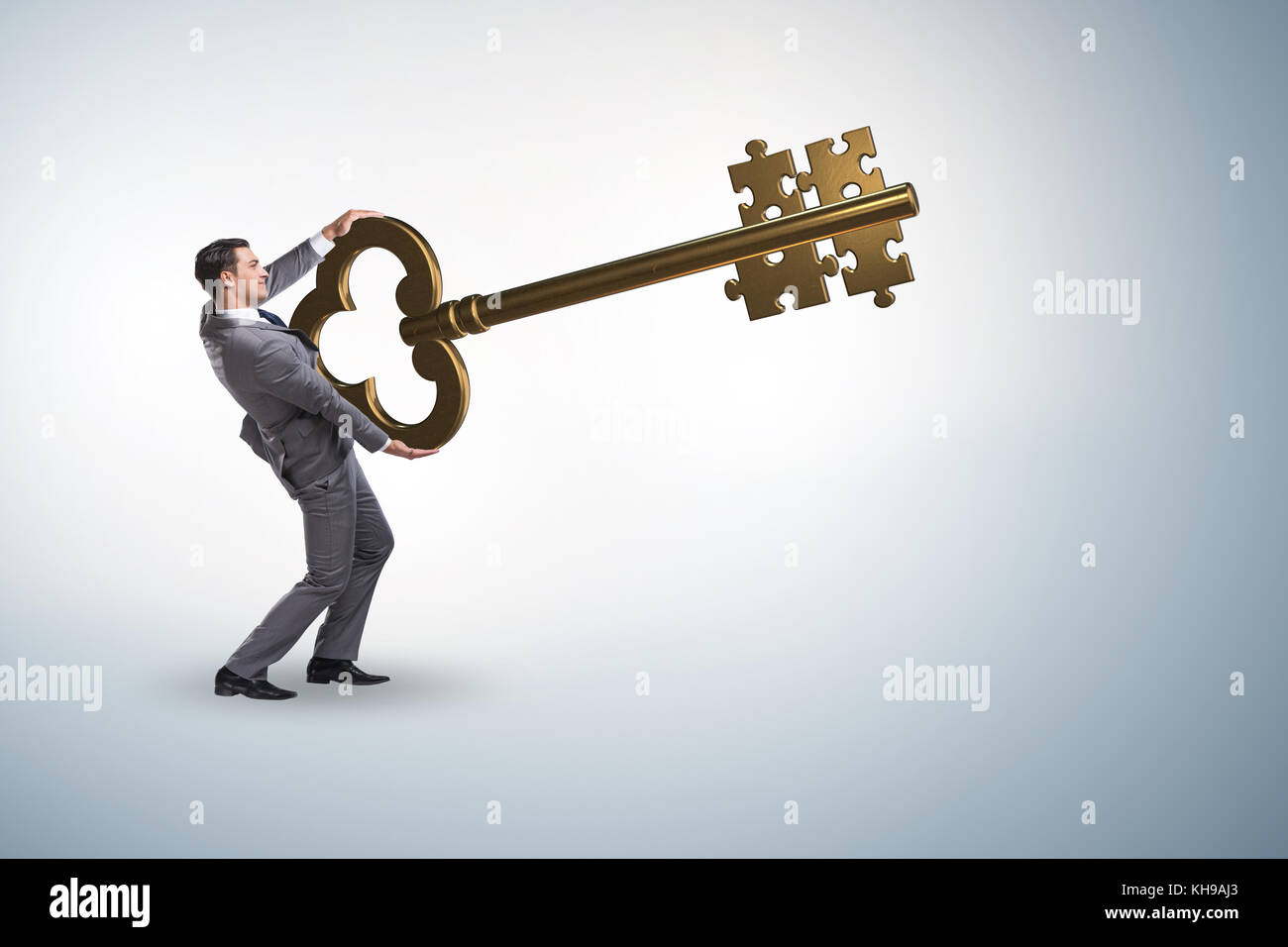 Businessman with key and jigsaw puzzle pieces Stock Photo - Alamy