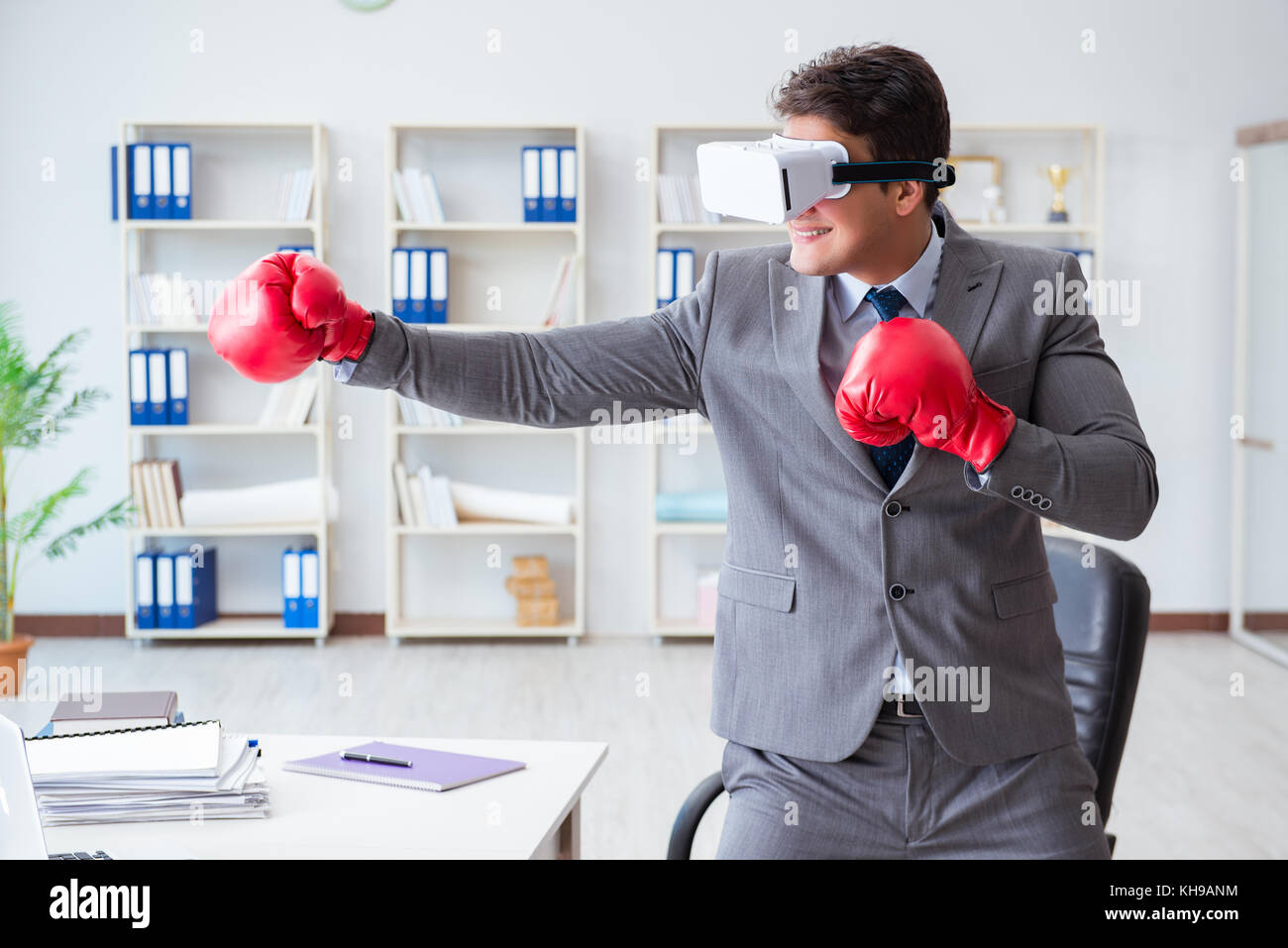 Man boxing in the office with virtual reality goggles Stock Photo - Alamy