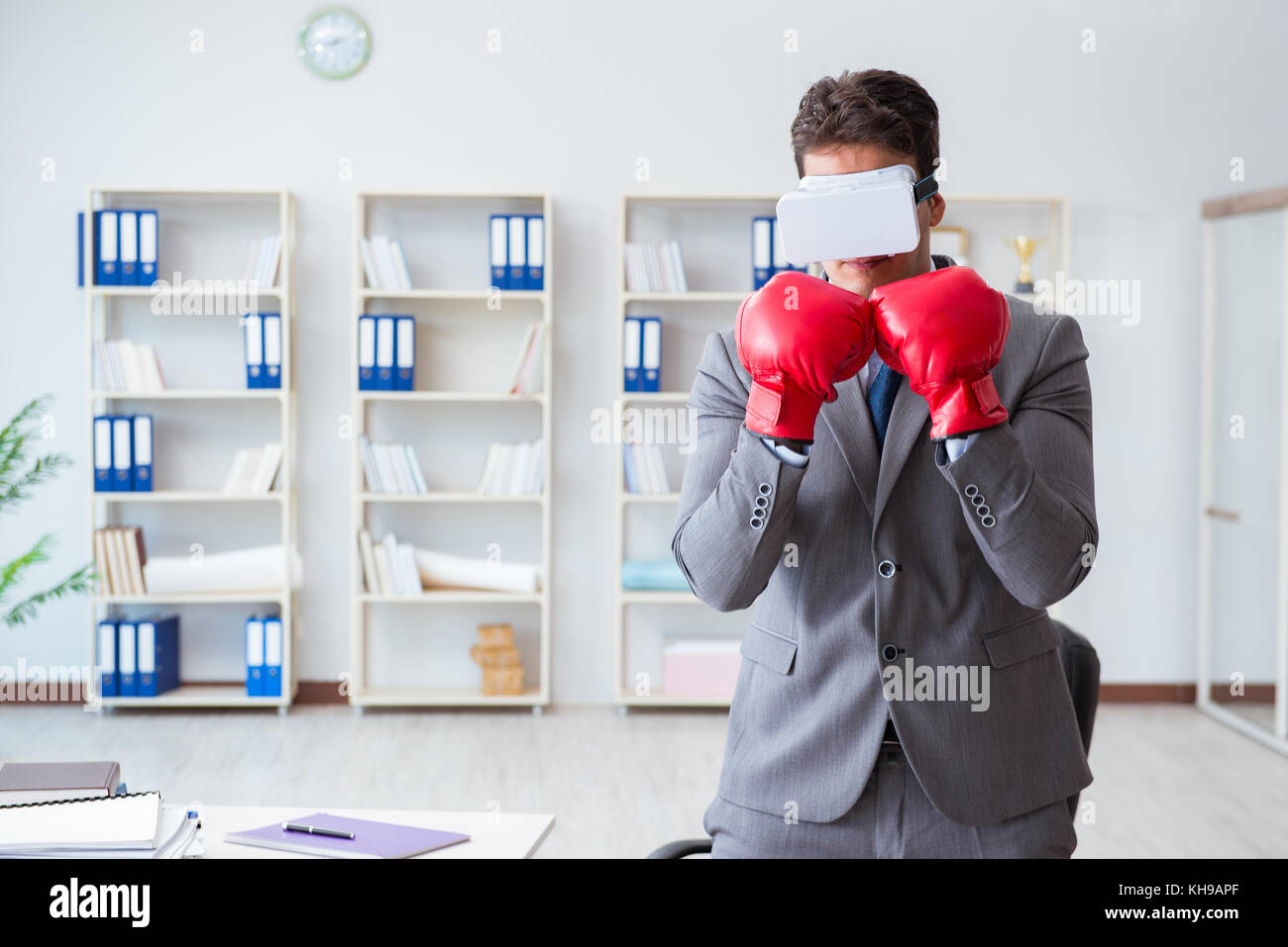Man boxing in the office with virtual reality goggles Stock Photo - Alamy