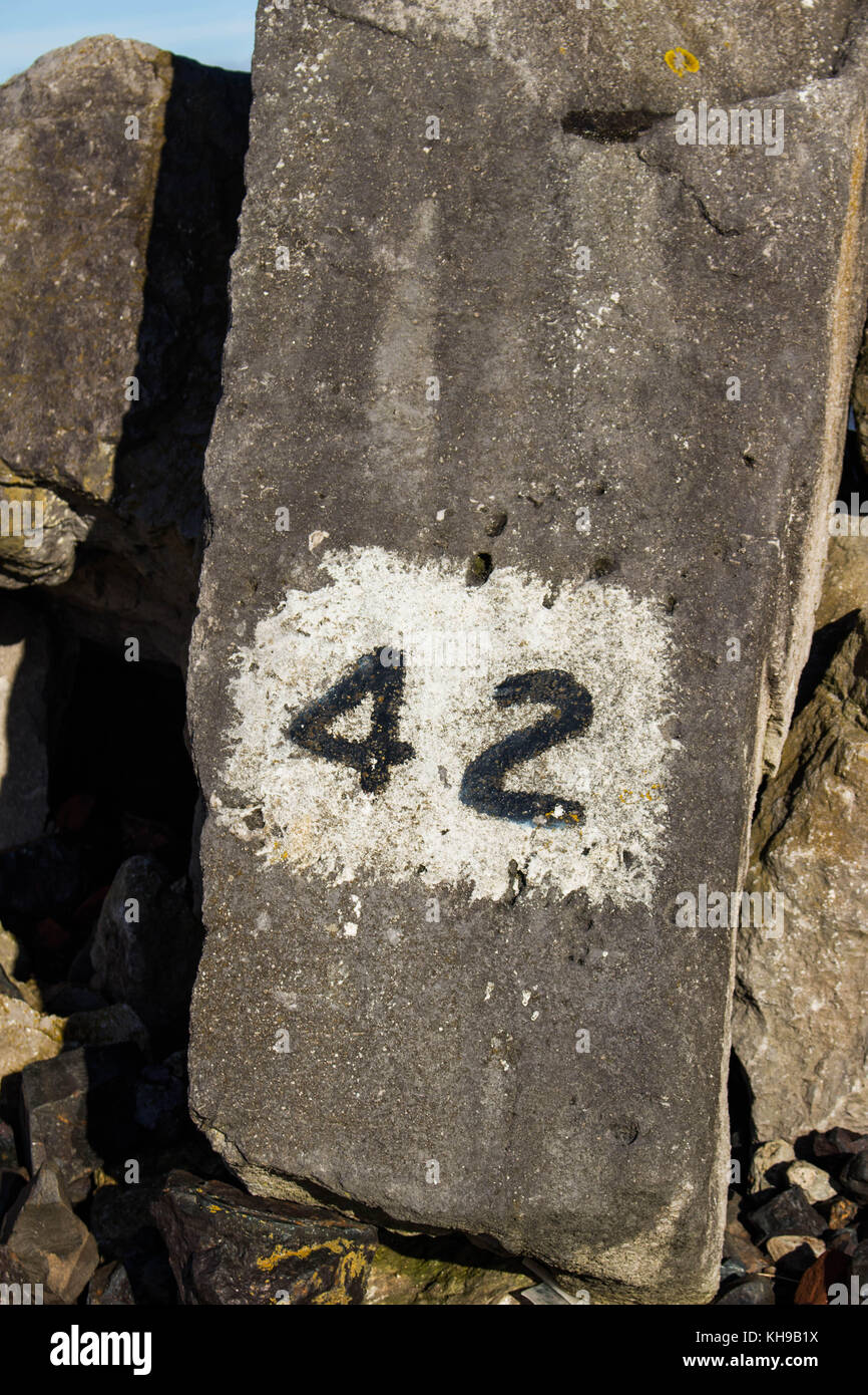the number 42 painted on white background on large rocks at coast Stock ...