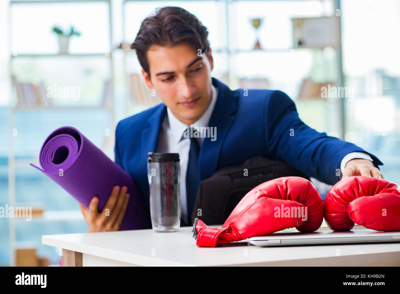 Man with boxing gloves in the office Stock Photo - Alamy