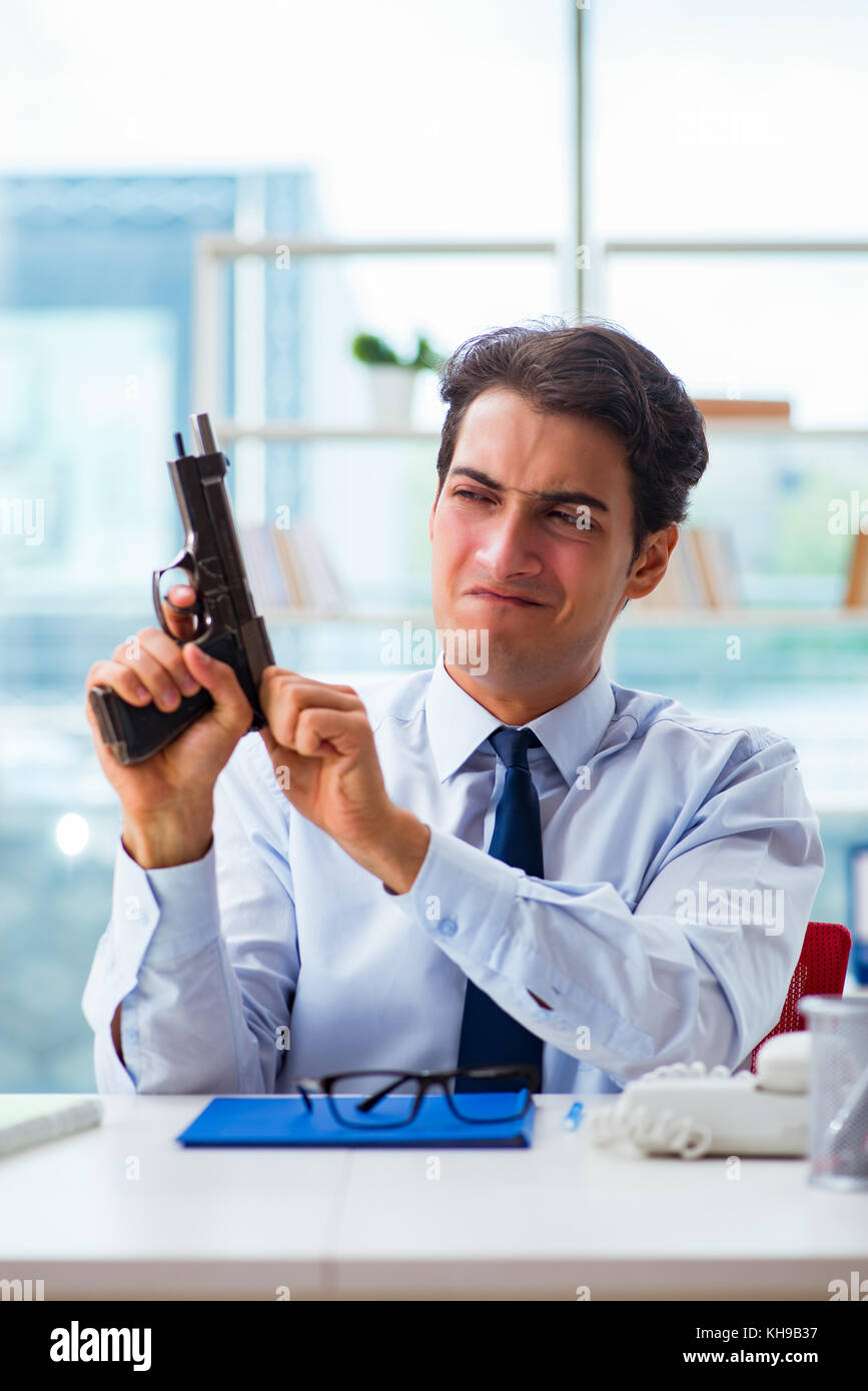 Angry businessman with gun thinking of committing suicide Stock Photo ...