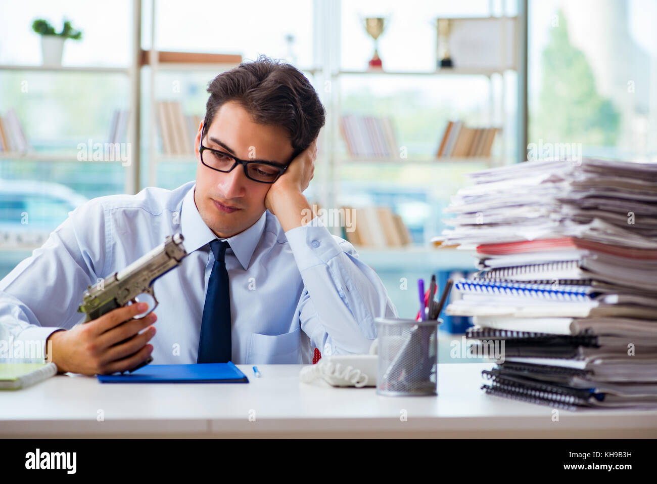 Angry businessman with gun thinking of committing suicide Stock Photo ...