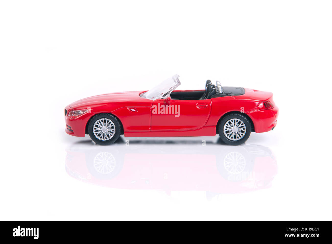 Red toy or model convertible sport car on white background Stock Photo ...
