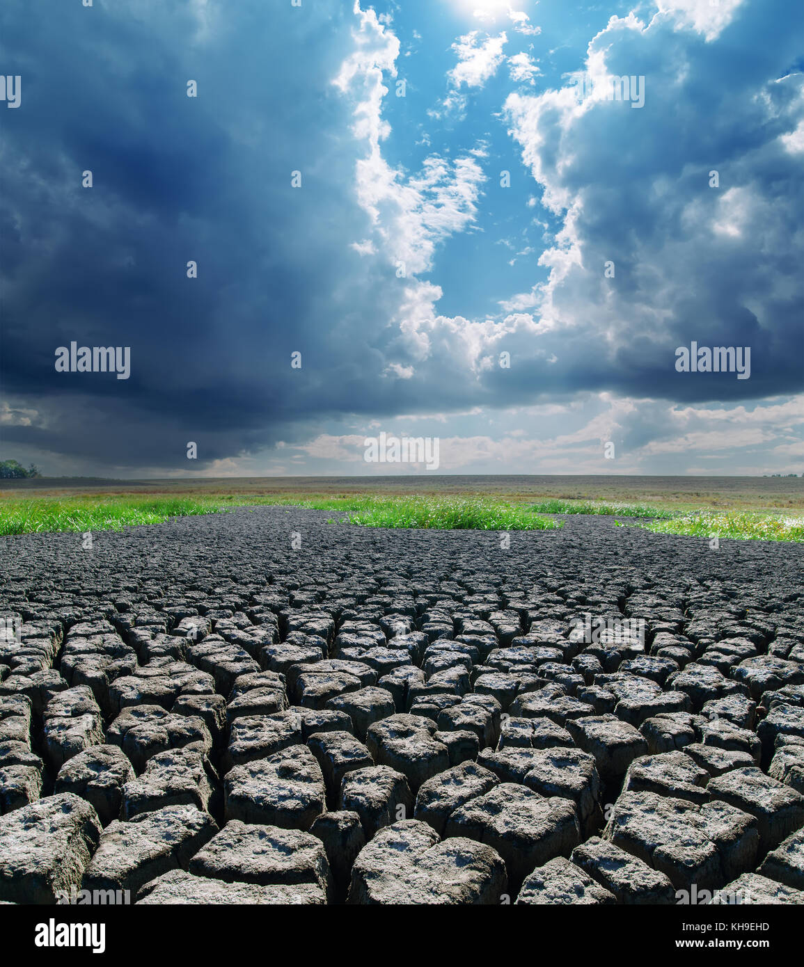 cracked earth under stormy clouds. global warming Stock Photo - Alamy