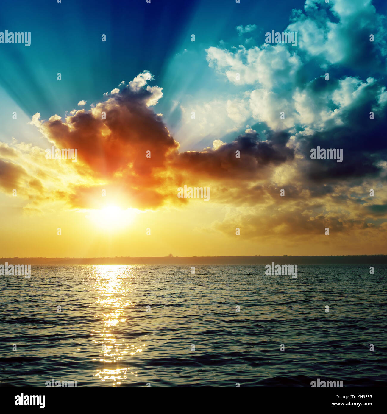 dramatic sunset over dark water Stock Photo - Alamy