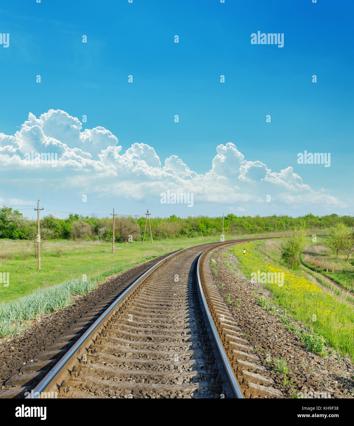 railway goes to horizon in green landscape Stock Photo - Alamy