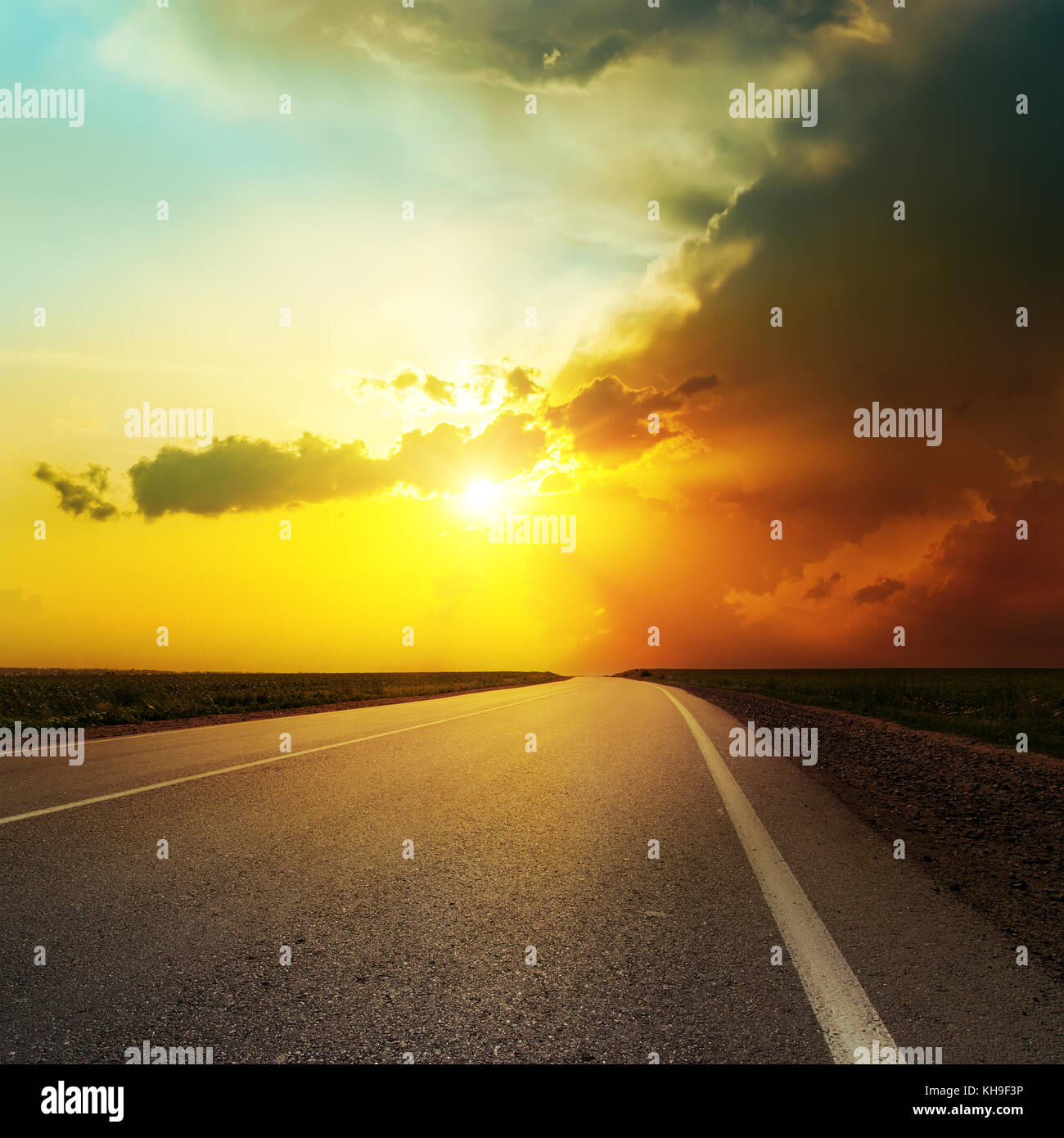 dramatic sunset over asphalt road Stock Photo - Alamy