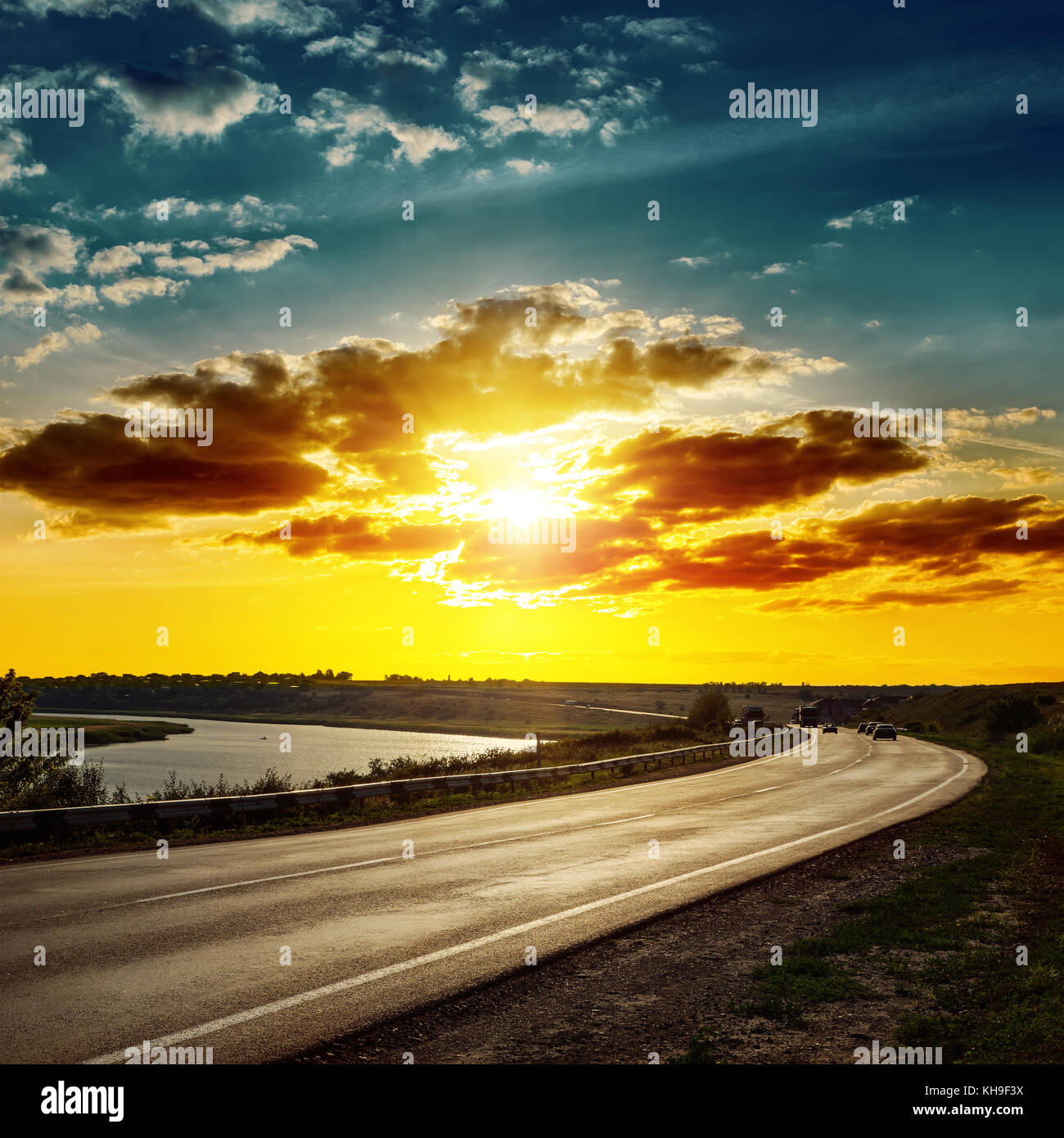 good sunset over asphalt road Stock Photo - Alamy