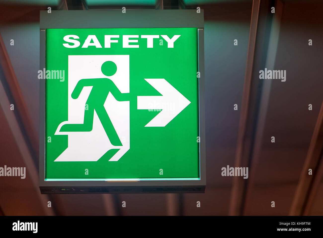 The emergency exit sign shows the direction of safety. The emergency ...