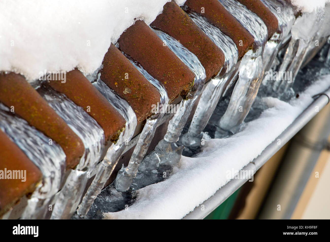 The water freeze on the roof when flows to the spout. Frozen outflow of ...