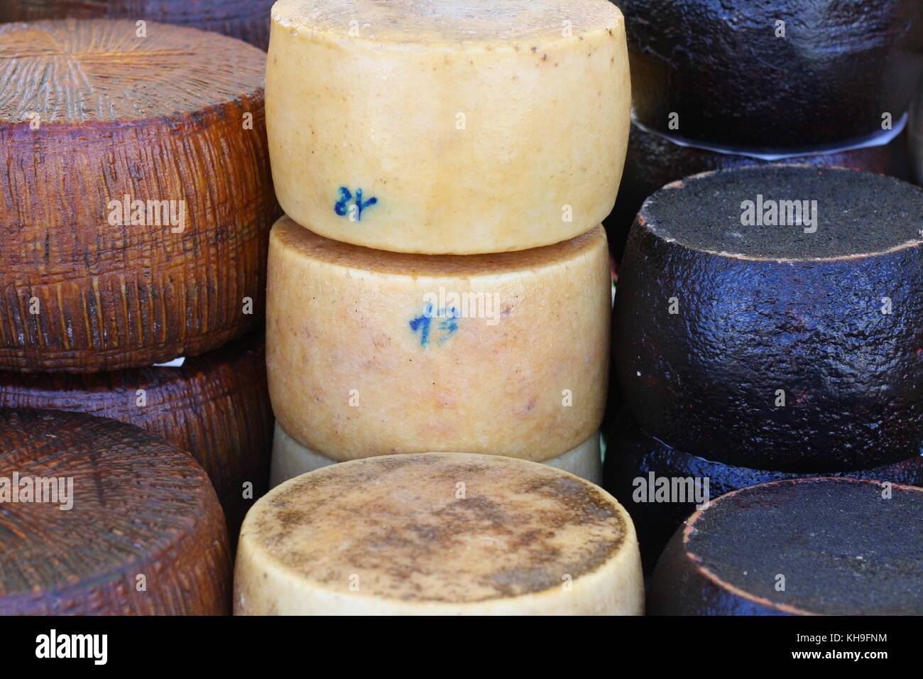 Whole cheese wheels on sale at the fresh food market Stock Photo - Alamy