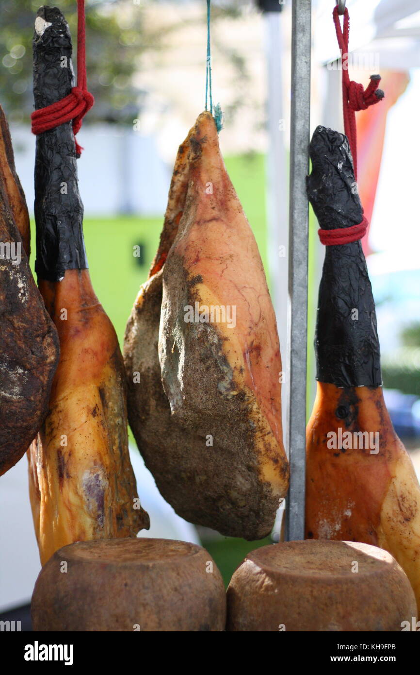Dried and cured ham hanging on sale Stock Photo - Alamy