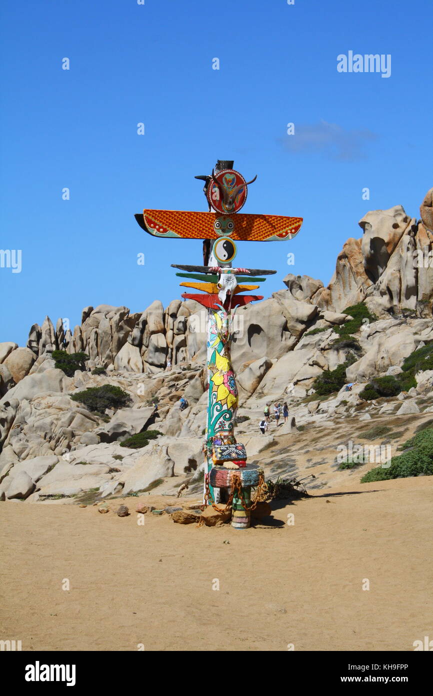 A colorful decorated totem column signaling one's grave on the beach ...
