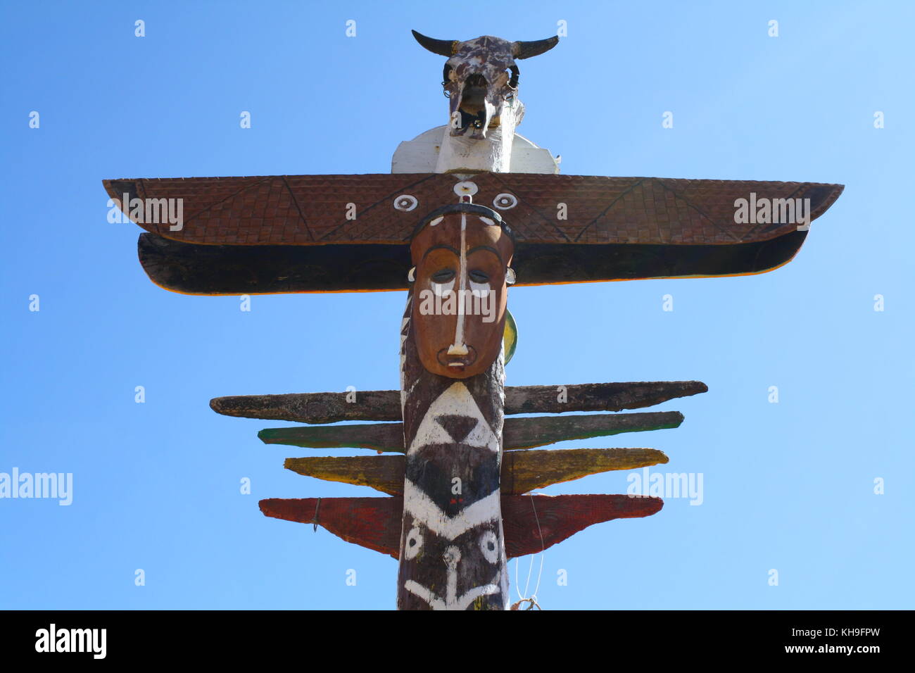 A colorful decorated totem column signaling one's grave on the beach ...