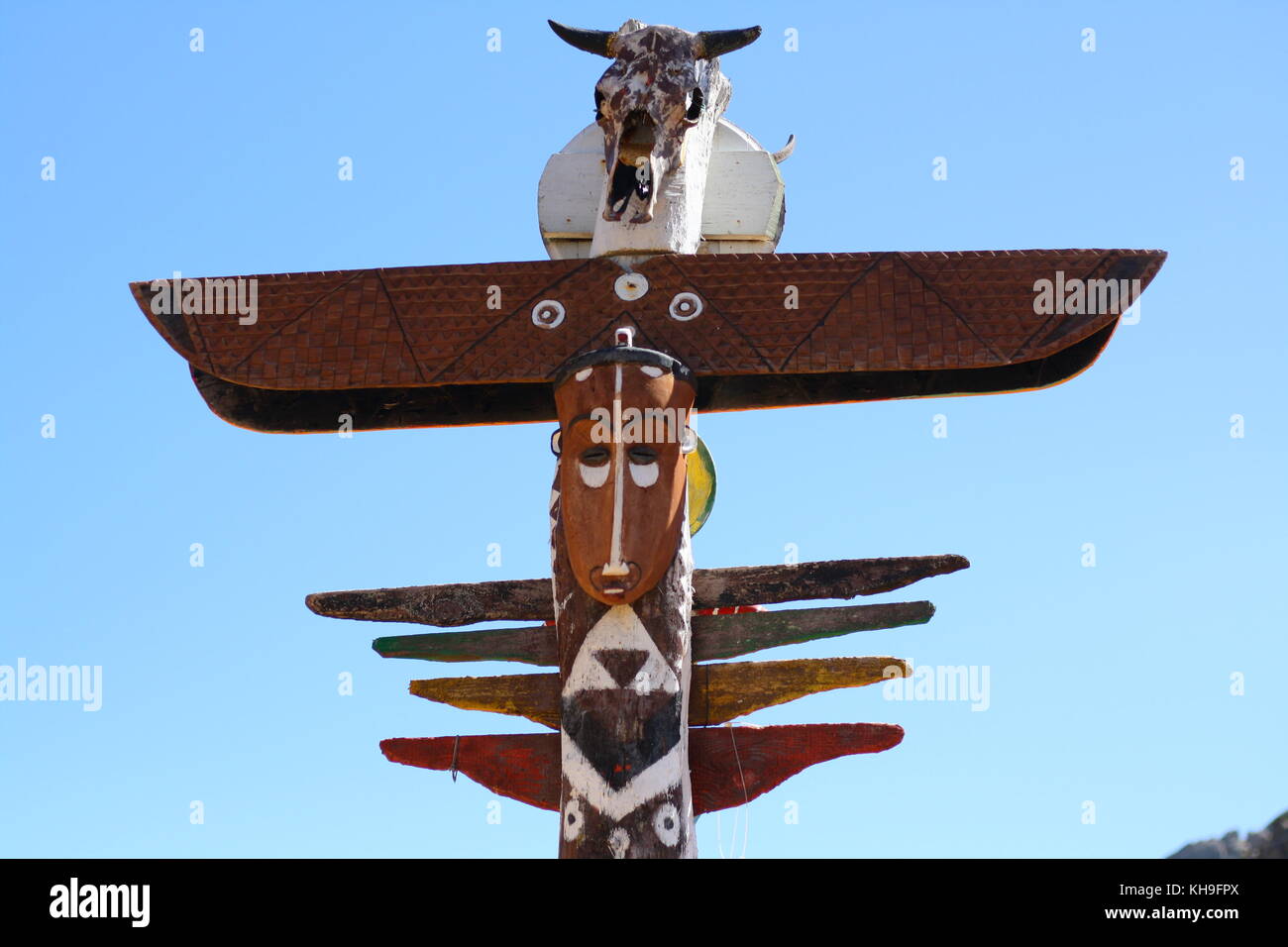 A colorful decorated totem column signaling one's grave on the beach ...