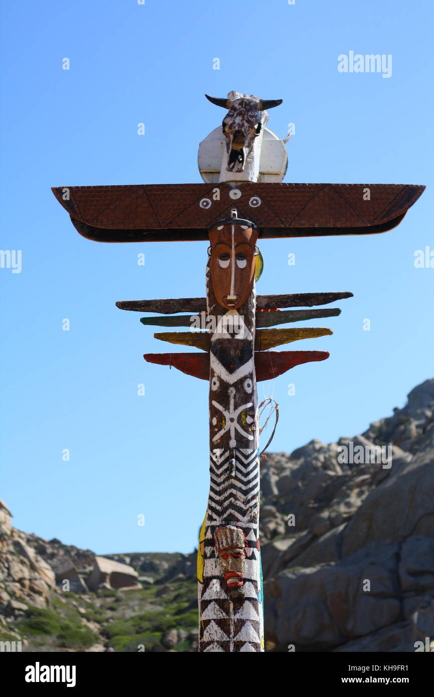 A colorful decorated totem column signaling one's grave on the beach ...