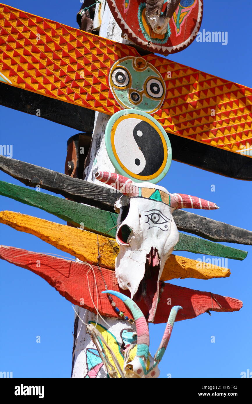 A colorful decorated totem column signaling one's grave on the beach ...