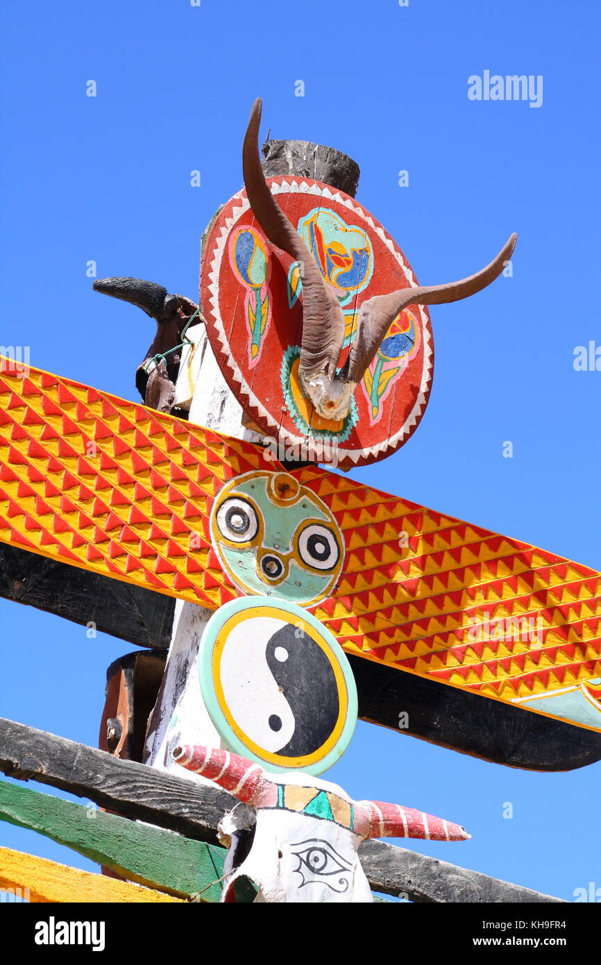 A colorful decorated totem column signaling one's grave on the beach ...
